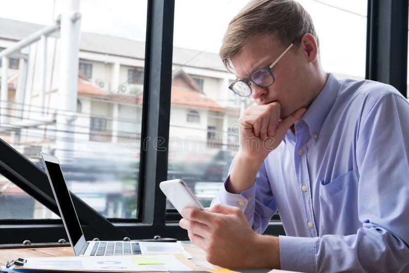 Thoughtful Businessman Use Mobile Phone at Workplace. Man Texting ... Thoughtful Businessman Use Mobile Phone at Workplace. Man Texting ...