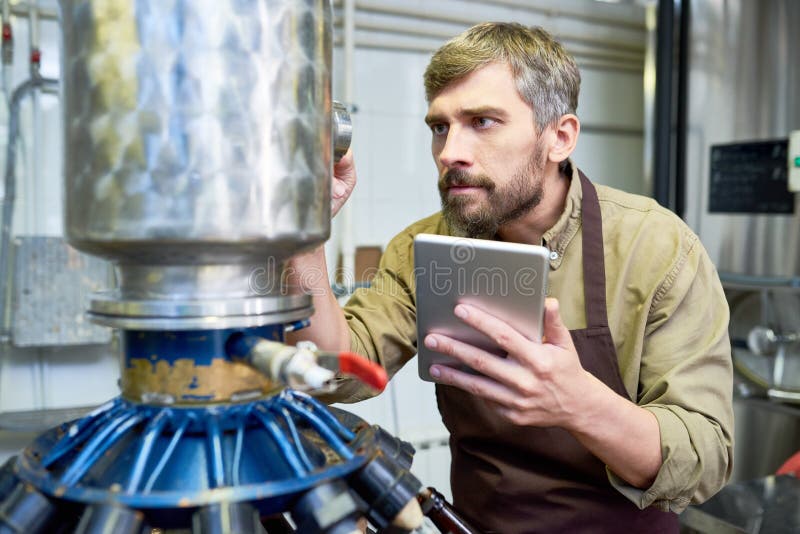 Busy Male Engineer Adjusting Brewery Equipment at Plant Stock Photo ...
