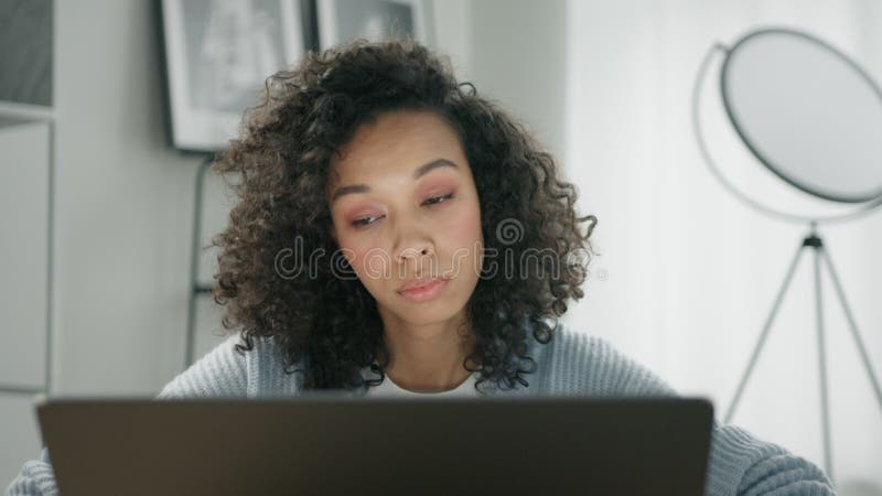 Thoughtful Concerned Afro Woman Working on Laptop Computer, Looking ...