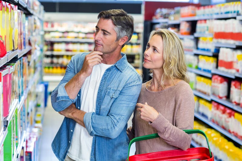 Thoughtful Couple Choosing a Product Stock Image - Image of holding ...