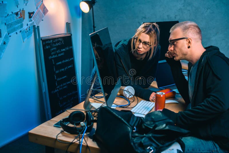 Thoughtful Couple of Hackers Looking at Computer Screen Together Stock ...