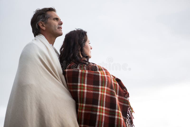Thoughtful Couple Sitting On Different Sides Of Bed Having A Dis Stock