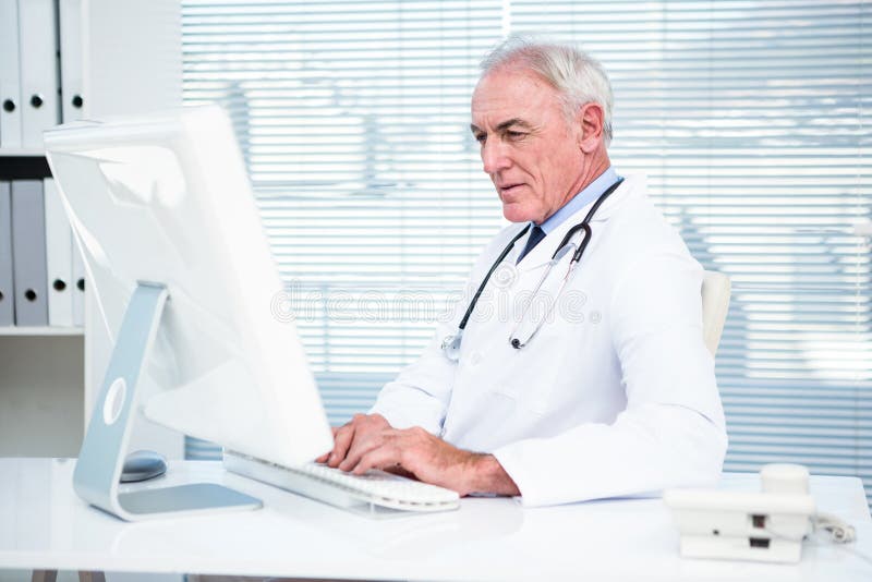 Thoughtful Doctor Working on Computer Stock Image - Image of ...