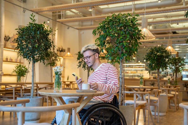 Thoughtful Dreamy Disabled Man in Wheelchair Drinking Coffee at Cafe ...