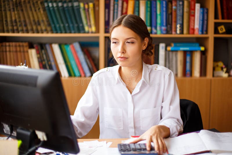 Thoughtful Female Administrative Assistant Checking Computer Reading ...
