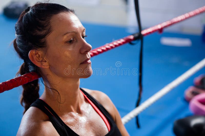 Thoughtful Female Boxer Leaning On Rope Stock Image - Image of adult ...