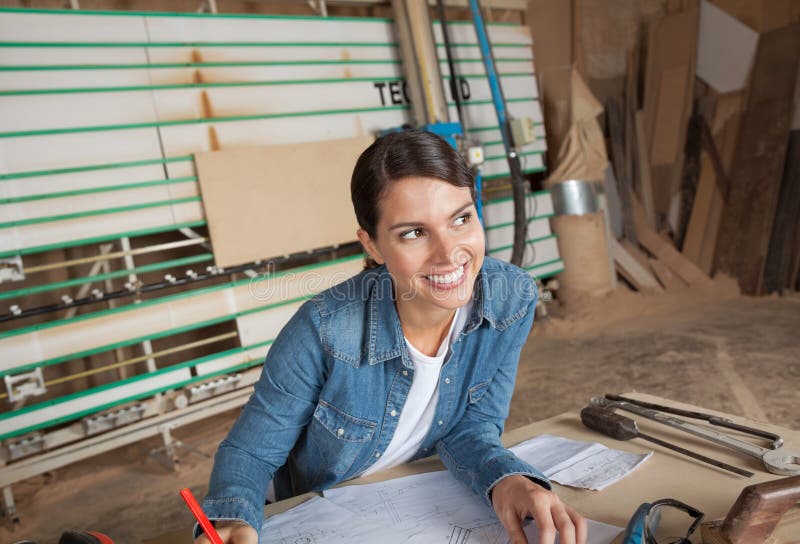 Thoughtful Female Carpenter Working on Blueprint Stock Photo - Image of ...