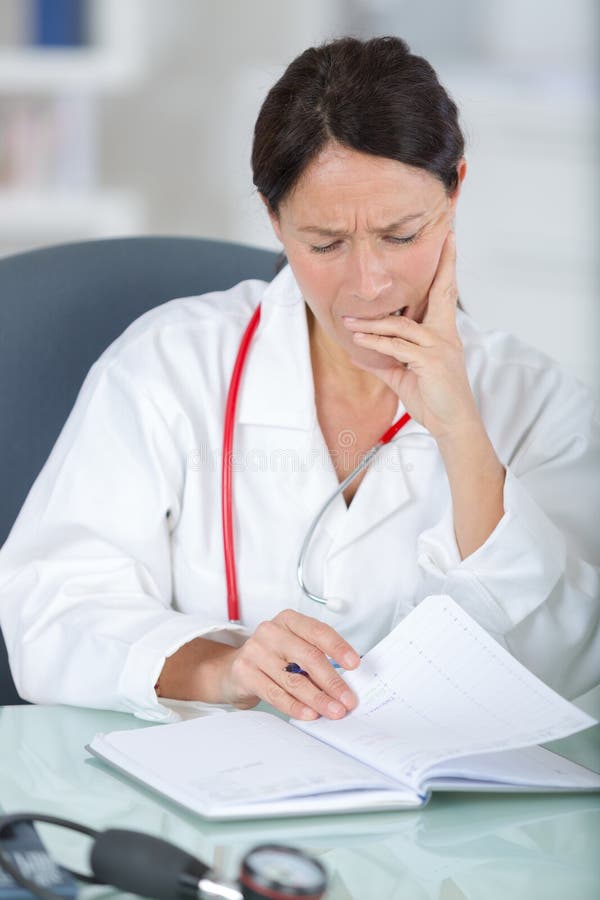 Thoughtful Female Doctor Holding File Stock Image - Image of health ...
