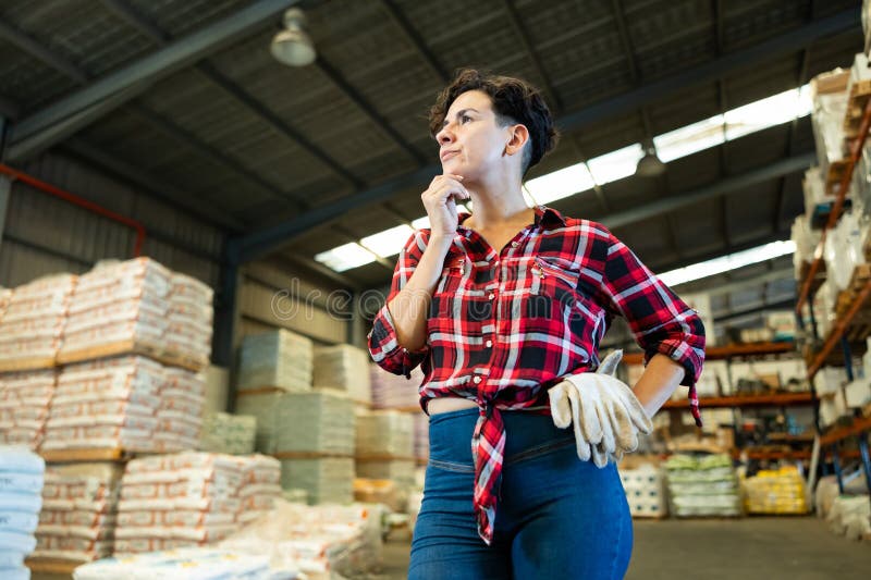 Thoughtful Female Storekeeper Looking for Tedious Goods in Building ...