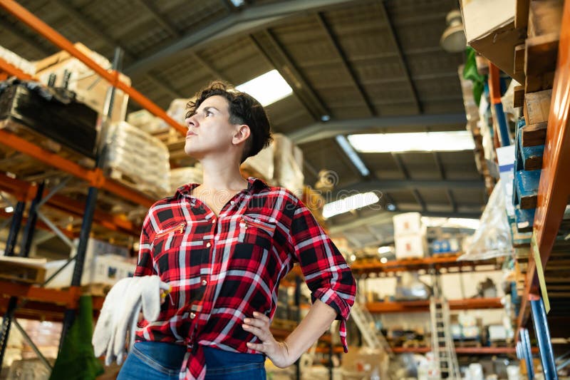 Thoughtful Female Storekeeper Looking for Tedious Goods in Building ...
