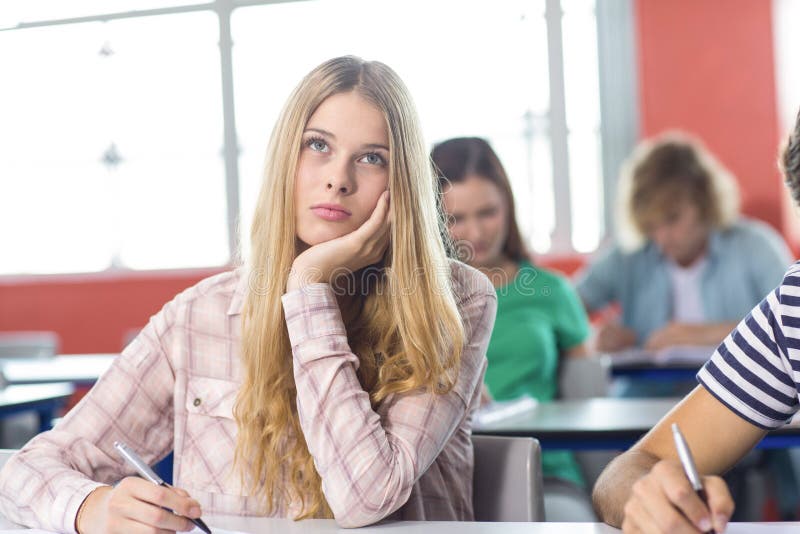 Thoughtful Female Student in Classroom Stock Photo - Image of looking ...