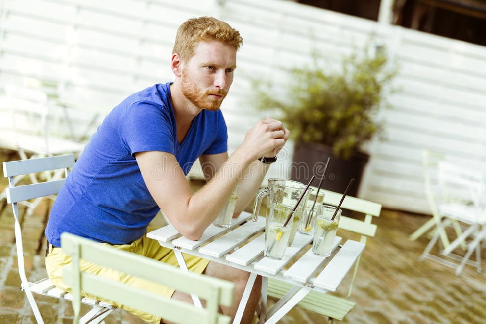 Thoughtful Ginger Male Waiting at a Table Outdoors Stock Photo - Image ...