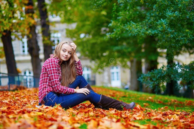 Thoughtful Girl Sitting on the Ground at Fall Stock Image - Image of ...