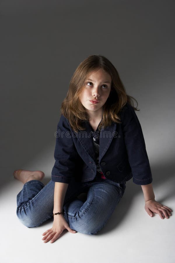 Thoughtful Girl Sitting in Studio Stock Image - Image of girl, full ...
