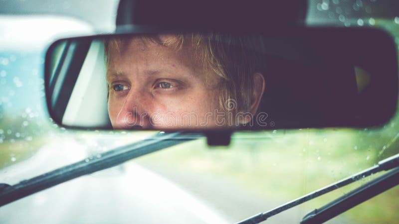Thoughtful Handsome Man Riding in Car through Mountains during Rainy ...
