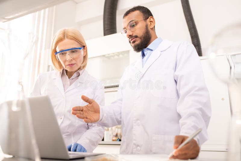 Thoughtful Laboratory Colleagues Finding Solution Stock Photo - Image ...