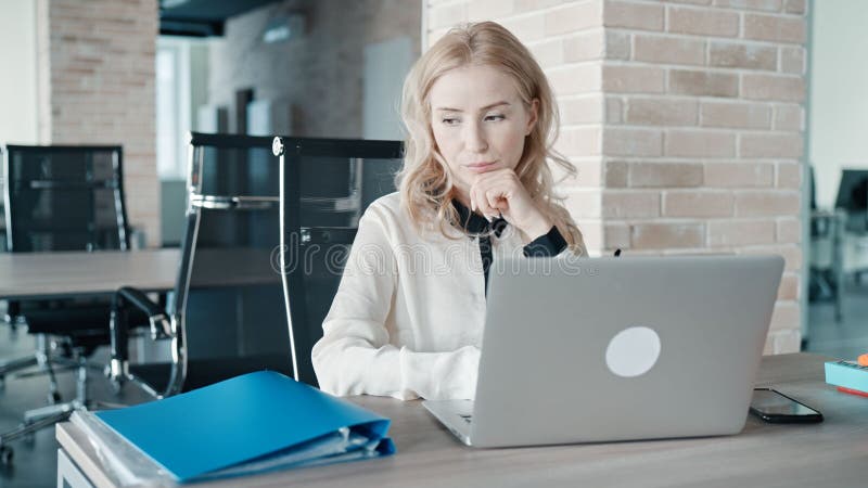 Thoughtful Lady in Front of Her Laptop in an Empty Office Staring at ...