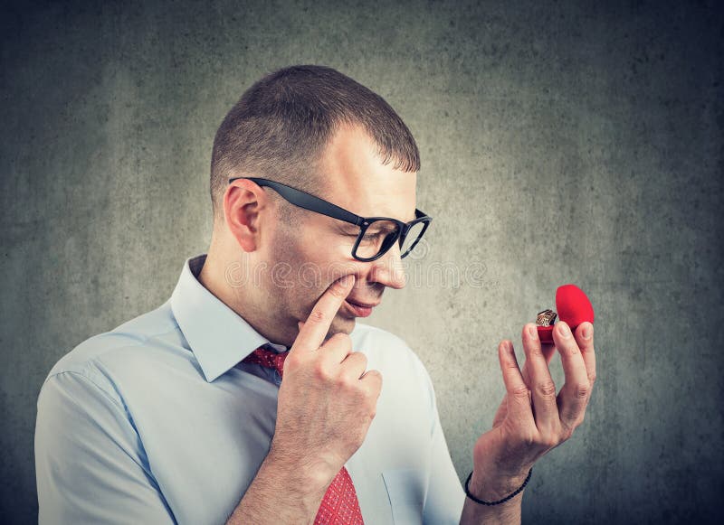 Thoughtful Man in Glasses Looking at a Ring with a Gemstone Stock Photo ...