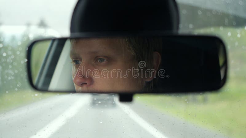 Thoughtful Man Riding in Car through Mountains during Rainy Day Stock ...