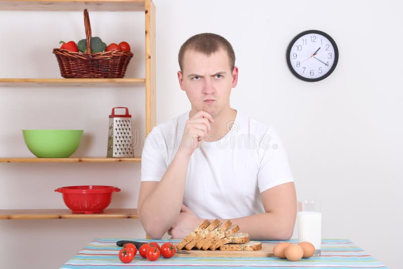 Thoughtful Man Sitting in the Kitchen Stock Image - Image of clock ...