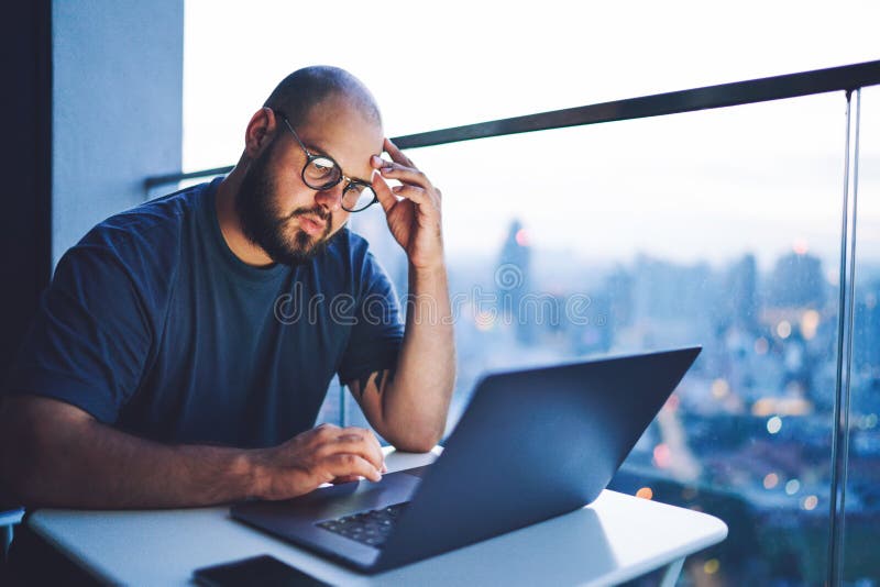 Picture a Man from Behind, he Was Sitting Behind a Wooden Design Table ...