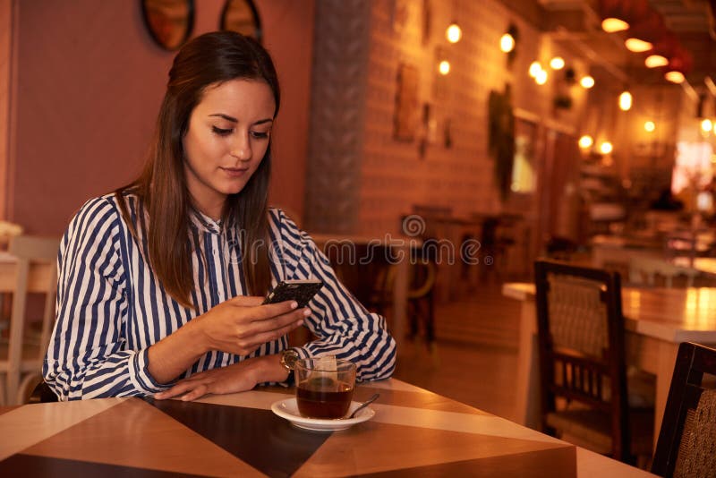 Thoughtful Millenial in Restaurant with Phone Stock Image - Image of ...