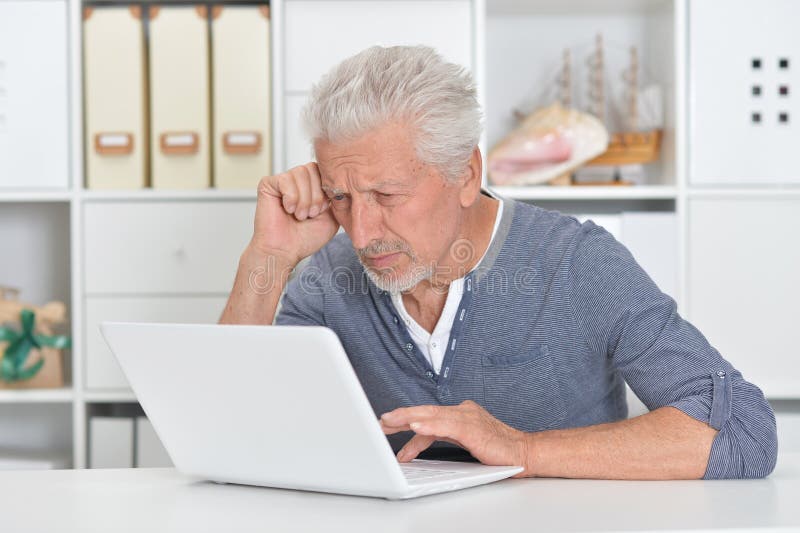 Thoughtful Old Man with Laptop at Home Stock Photo - Image of indoor ...