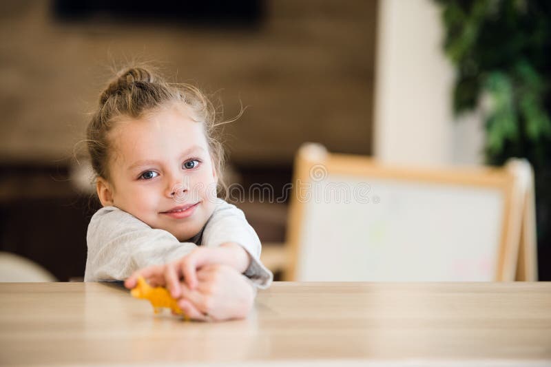Thoughtful Portrait of Little Girl Lay on the Table Stock Photo - Image ...