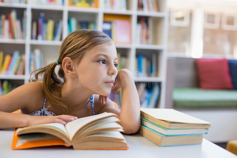 Thoughtful Boy Reading Book in Library Stock Image - Image of cute ...