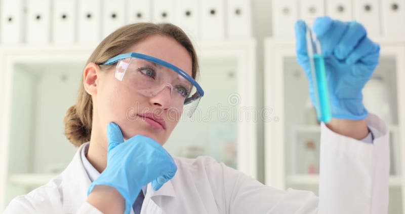 Thoughtful Scientist Examines Blue Liquid in Glass Tube Stock Footage ... Thoughtful Scientist Examines Blue Liquid in Glass Tube Stock Footage ...