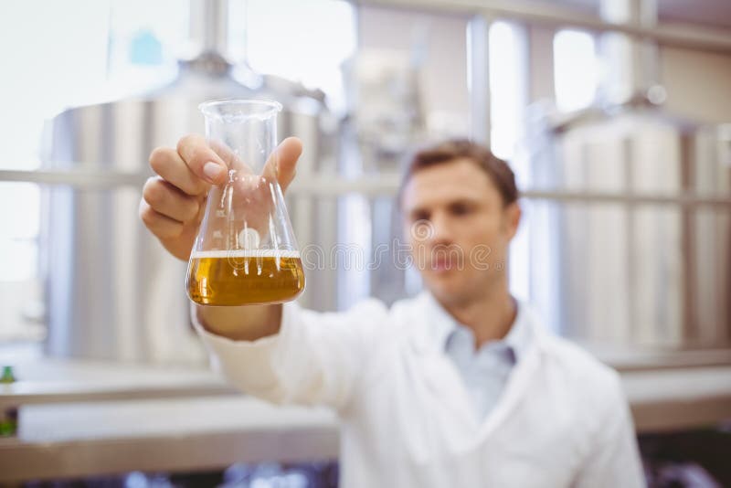 Thoughtful Scientist Holding a Beaker Stock Photo - Image of focus ...