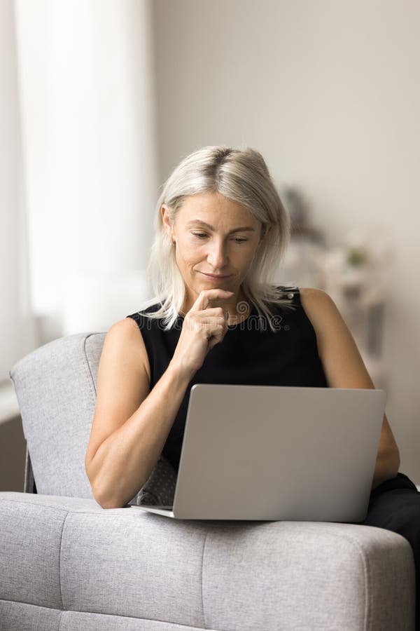 Thoughtful Senior Freelancer Woman Working at Laptop from Home Stock ...
