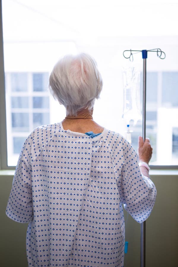 Thoughtful Senior Patient Standing at Hospital Stock Photo - Image of ...