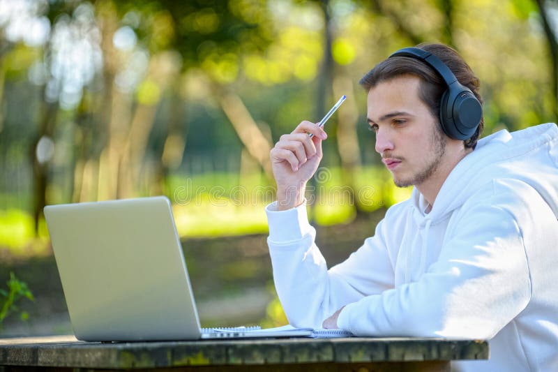 Young Guy is Studying Outdoors Sitting in the Park Stock Image - Image ...