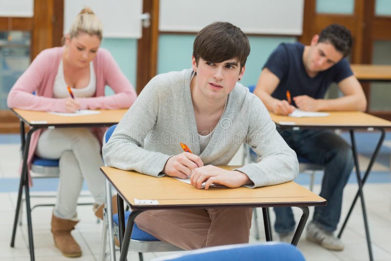 Thoughtful student writing stock photo. Image of paper - 30881574
