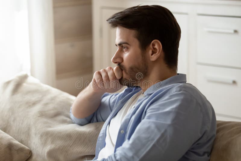 Thoughtful Upset Man Pondering Problem Solving, Sitting on Couch Stock ...