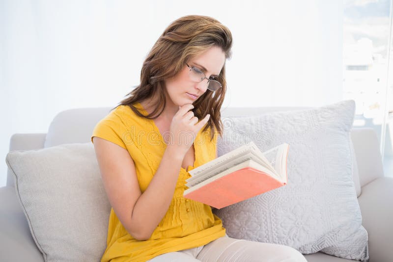 Thoughtful Woman Reading Book Stock Photo - Image of household ...