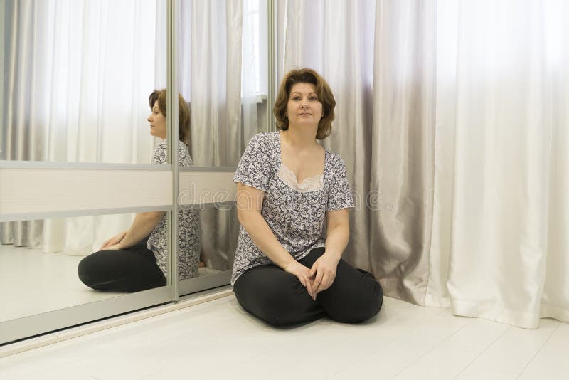 Thoughtful Woman Sitting in Corner of Room on the Stock Image - Image ...