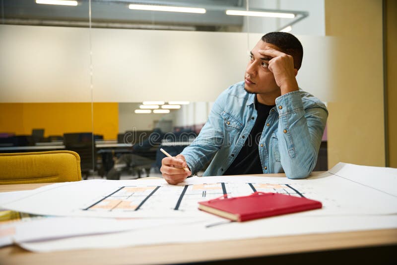 Thoughtful Young Architect Sitting at Table while Leaning on Hand Stock ...