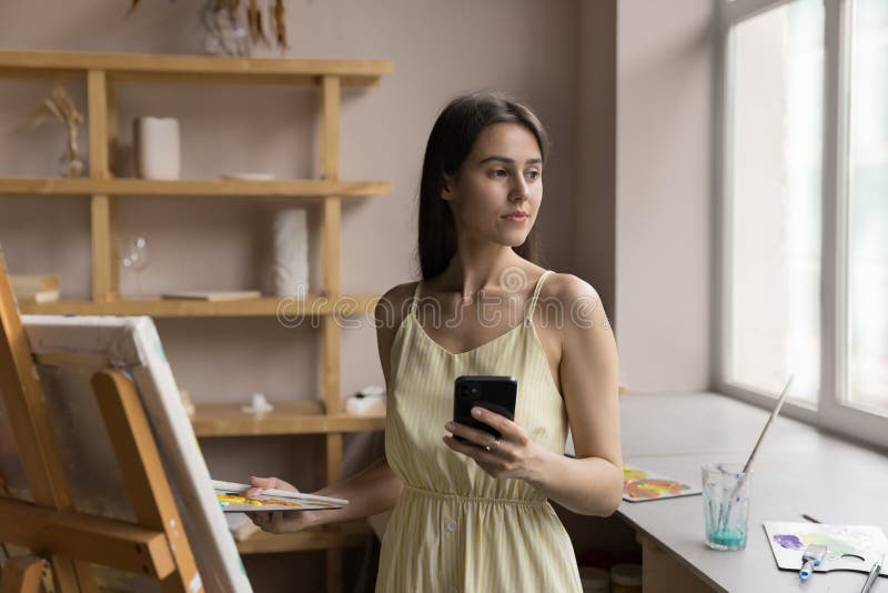 Thoughtful Young Artist Using Online Application, Searching for ...