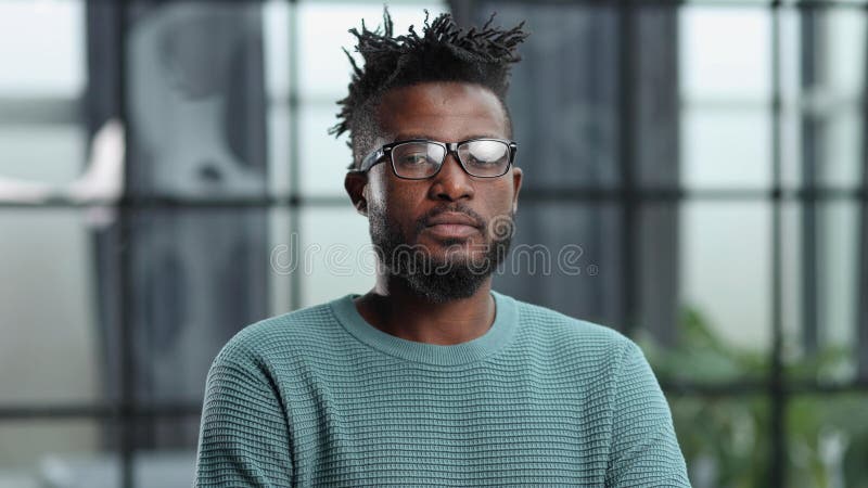 Thoughtful Young Black Man in Glasses Looking Straight Ahead Stock ...