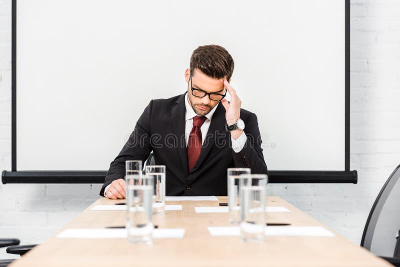 Thoughtful Young Businessman Working Alone Stock Photo - Image of table ...
