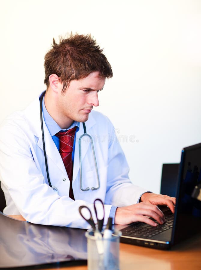 Thoughtful Young Doctor Working on a Computer Stock Image - Image of ...