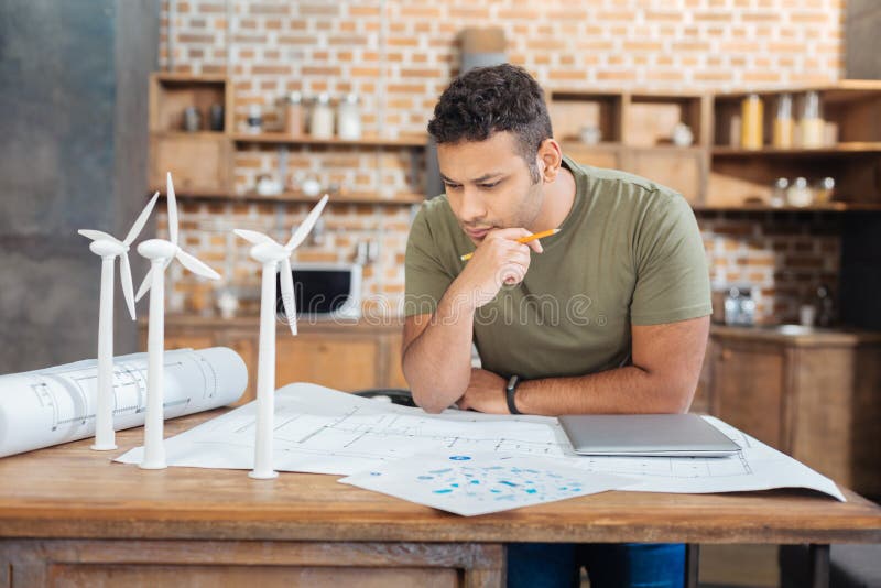 Thoughtful Young Engineer Looking at the Scheme in Front of Him Stock ...