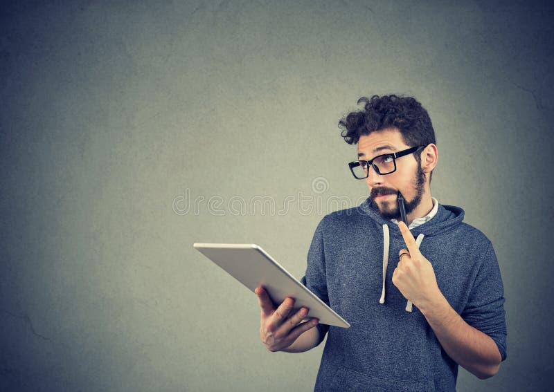Thoughtful Young Man with Tablet Computer Planning Stock Image - Image ...