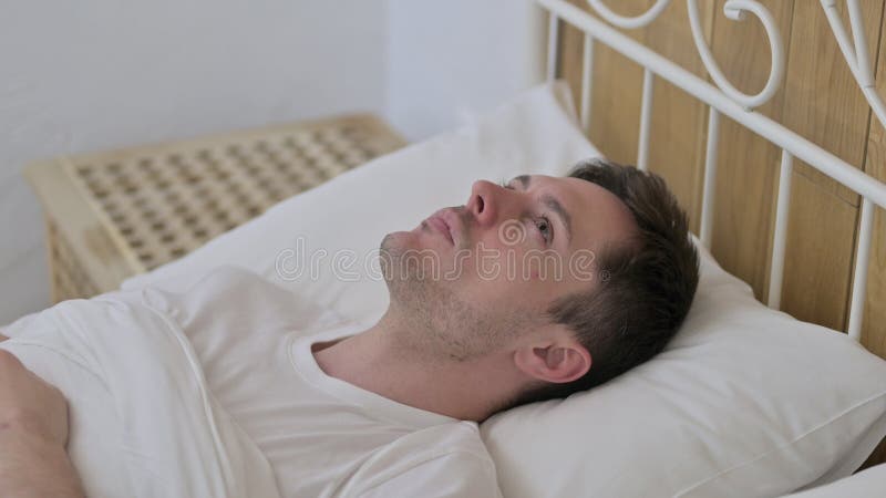 Thoughtful Young Man Awake in Bed Thinking Stock Photo - Image of ...