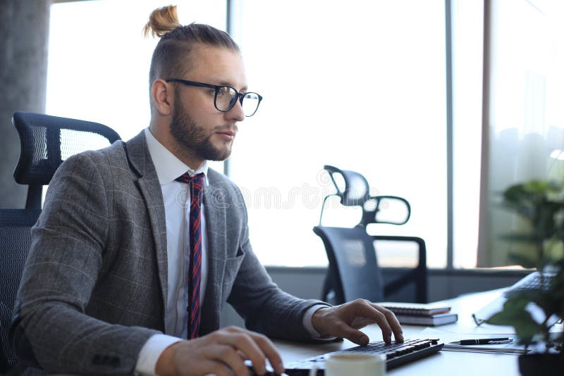 Thoughtful Young Man in Full Suit Working Using Computer while Sitting ...