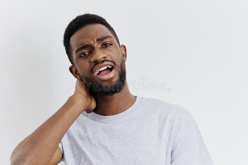 Contemplative Young Man with Hand on Head, Gazing Upward with an ...