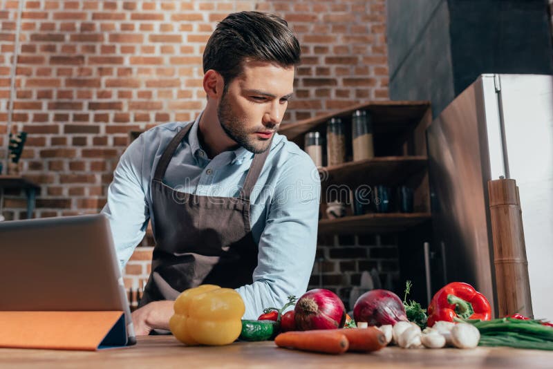 Thoughtful Young Man at Kitchen with Various Vegetables Stock Image ...