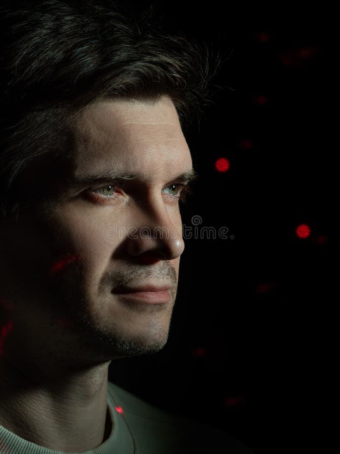 A Thoughtful Young Man Looks To the Right Virtual Interface on His Face ...